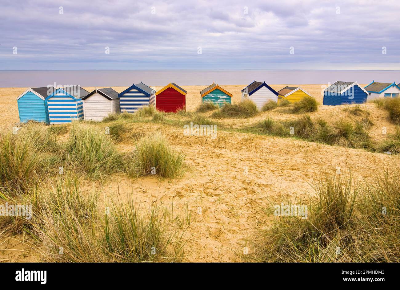 Golden sandy dunes and colourful seaside beach huts at Southwold ...