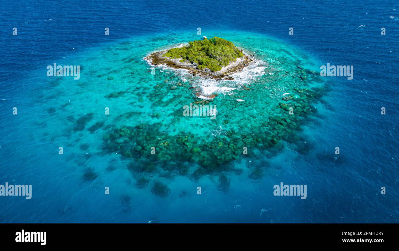 Aerial of a small island in the lagoon of the Rangiroa atoll, Tuamotus ...