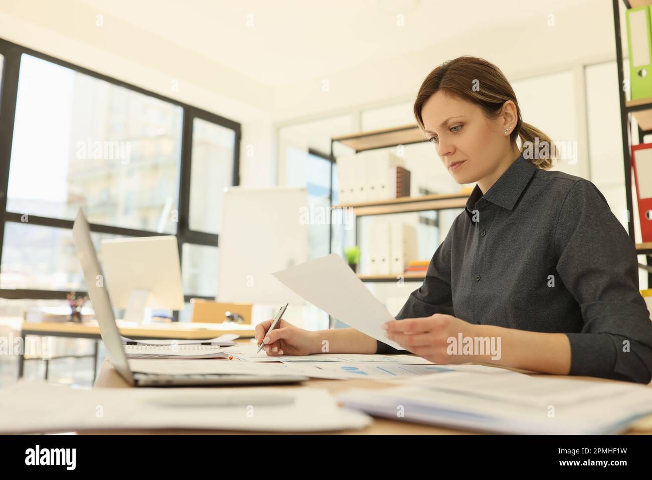 Focused woman checks financial report hi-res stock photography and ...