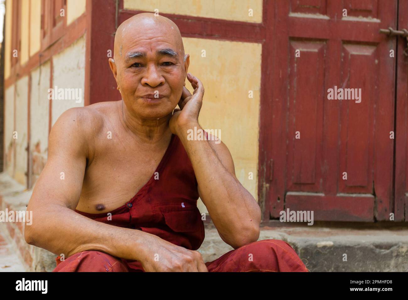 Senior monk resting outside of Shwenandaw Temple, Mandalay, Myanmar ...