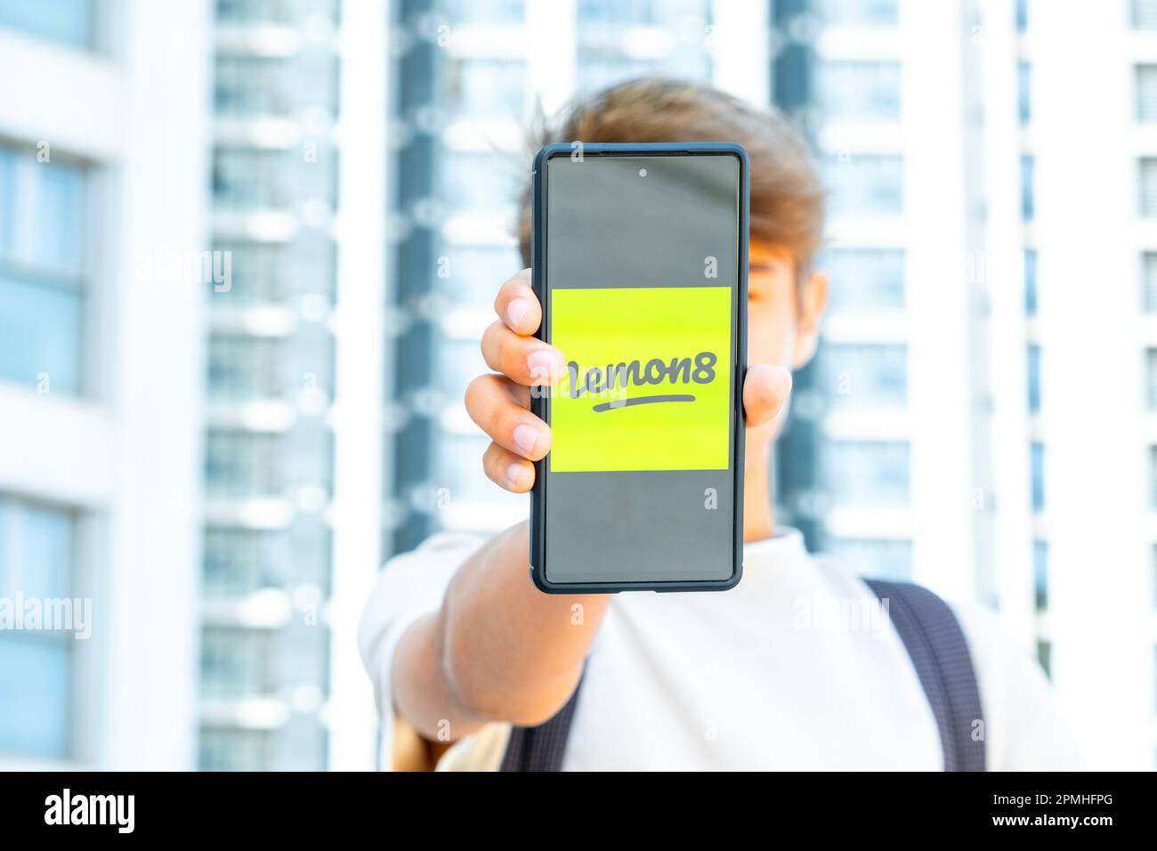 Benidorm, Spain - April 06, 2023: Teenage boy show phone with open content sharing platform with ...