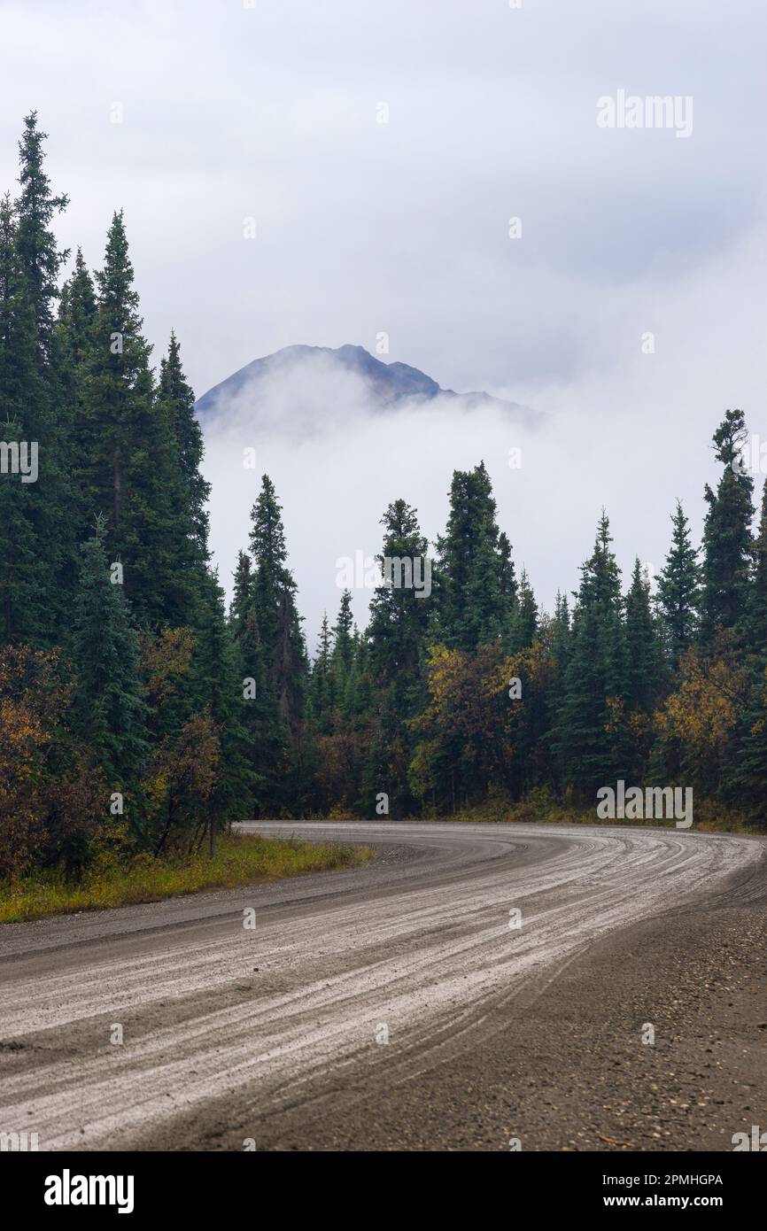 Mountain rising above low-hanging clouds at Denali Parks Highway in ...