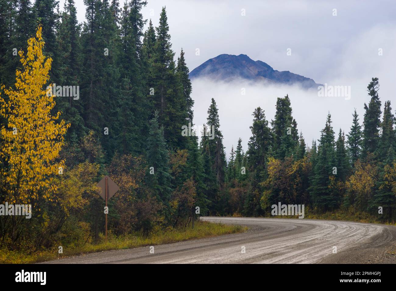 Mountain rising above low-hanging clouds at Denali Parks Highway in ...