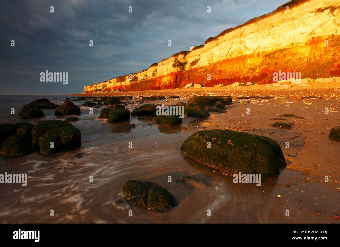 Midsummer evening sunlight on cliffs at Hunstanton, Norfolk, England ...