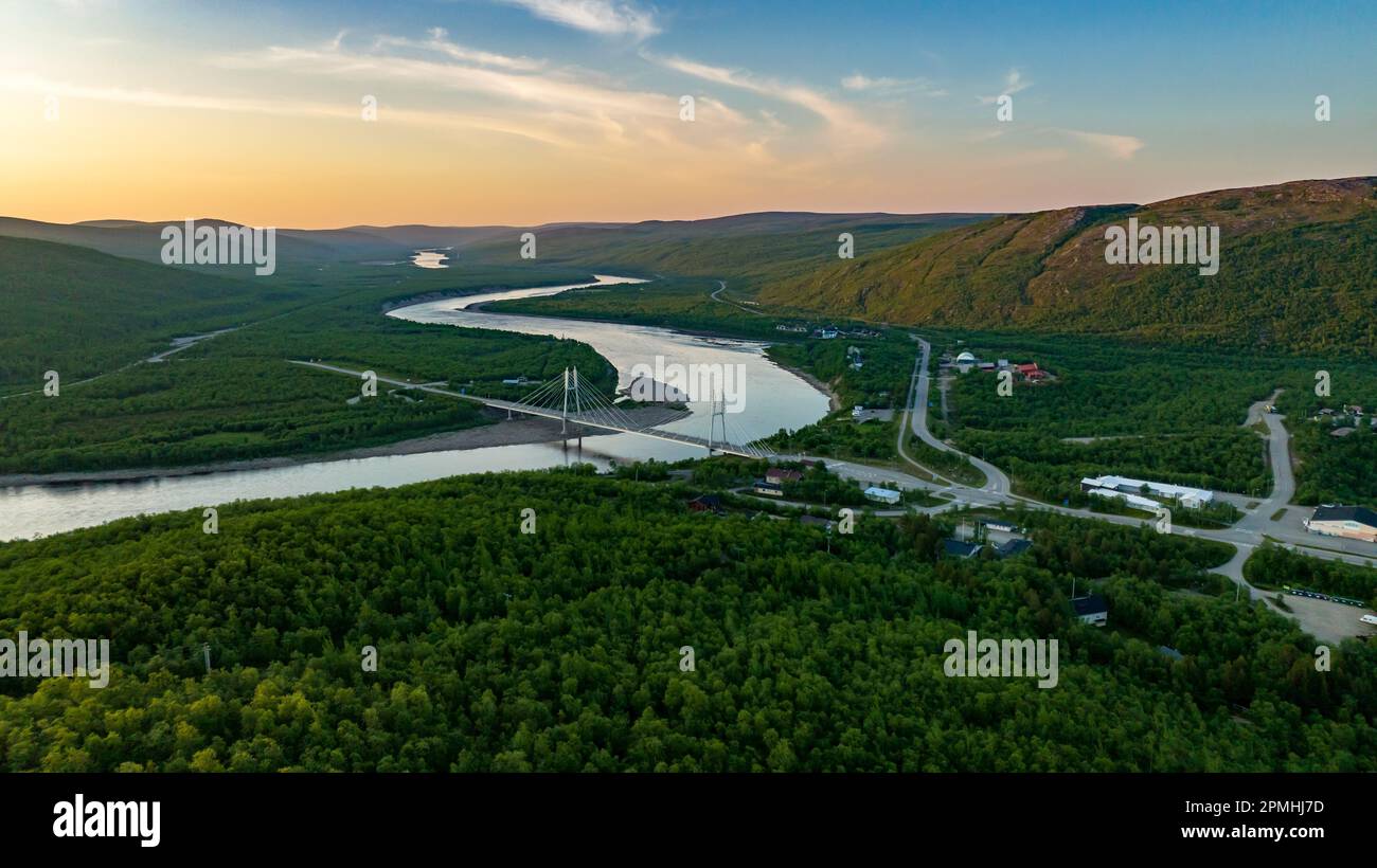 Aerial view of the Sami Bridge and Teno river, midnight sun in Utsjoki ...