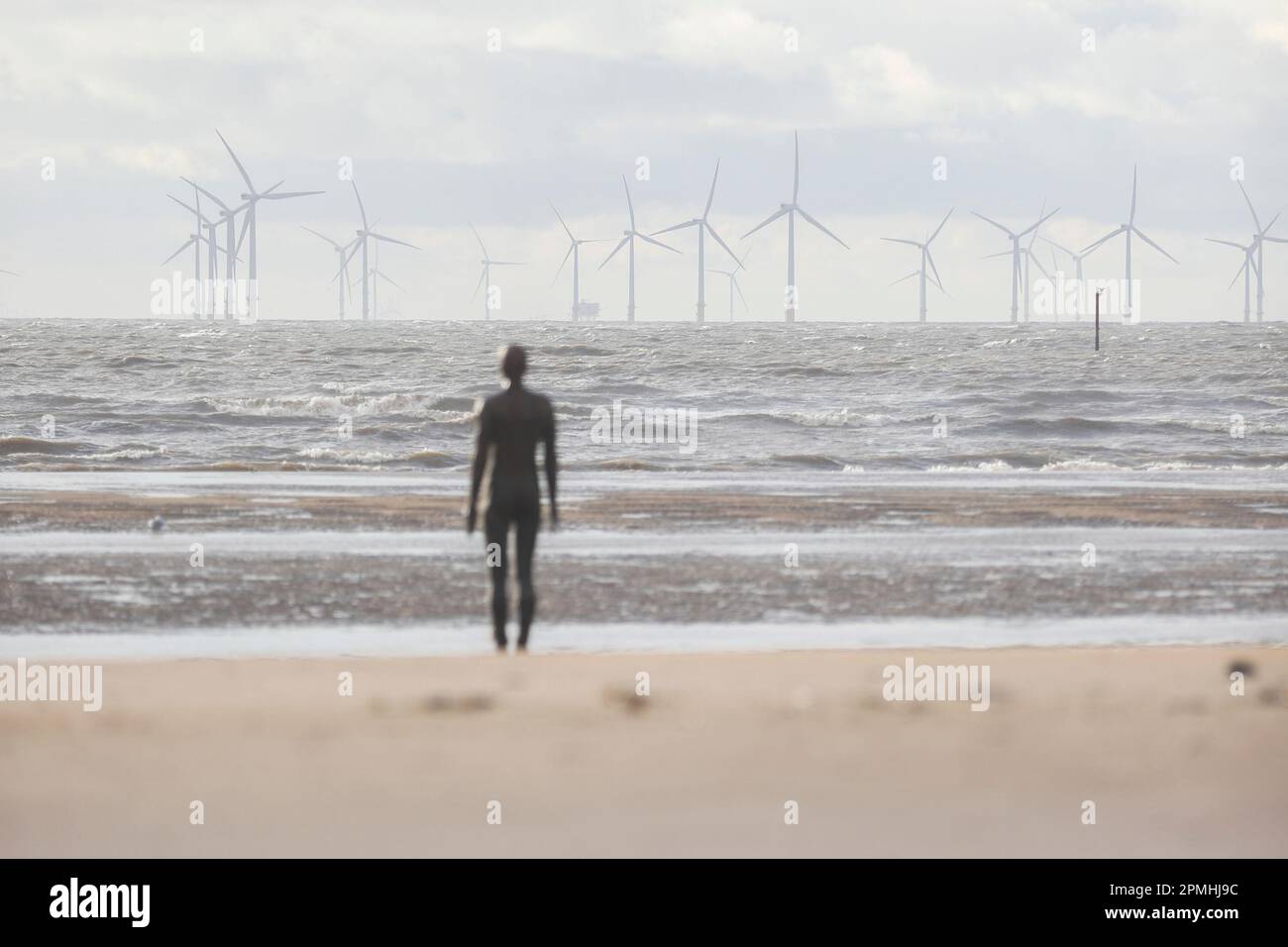 Crosby, UK. The Iron Men at Crosby Beach look out over the Burbo Bank ...