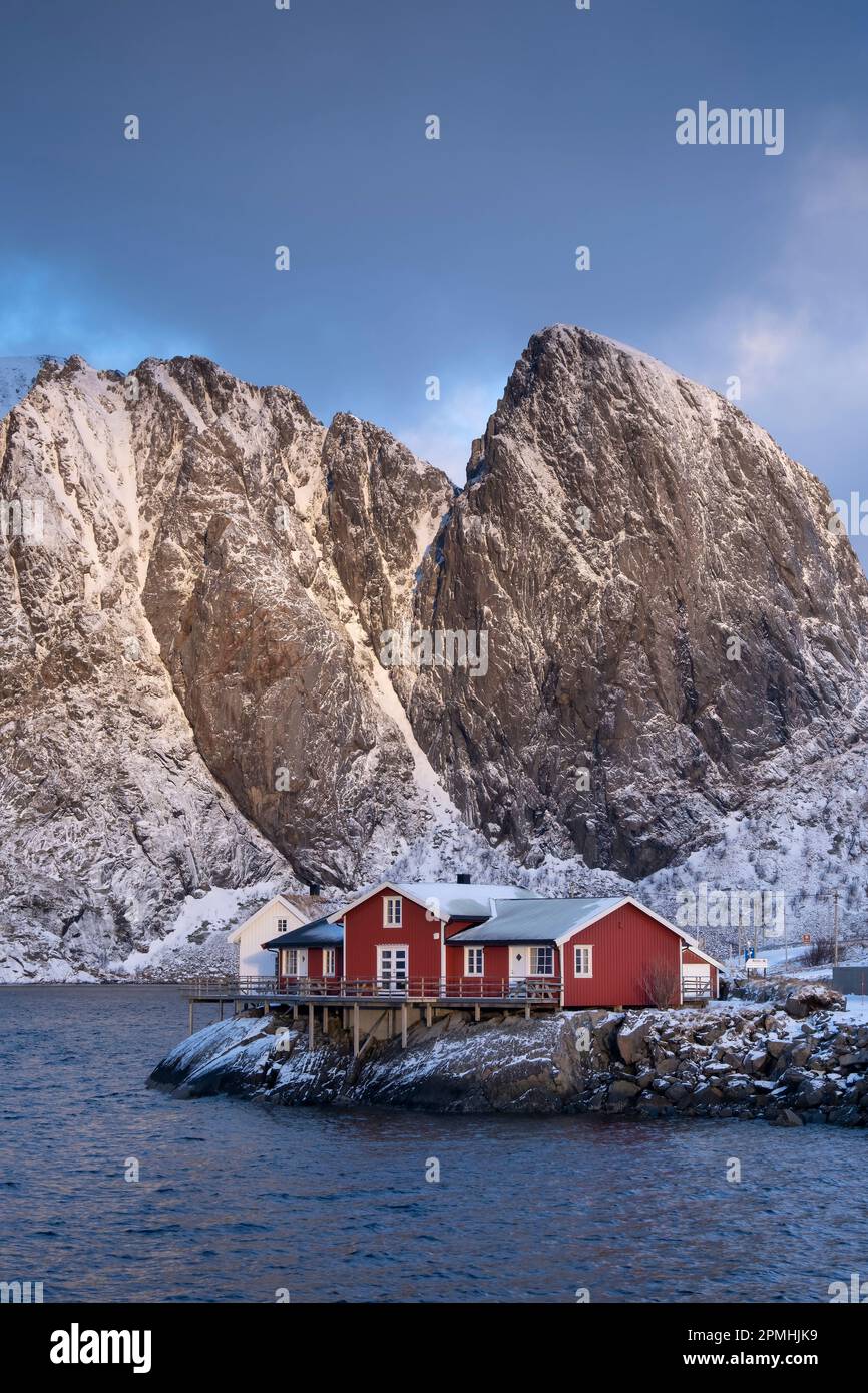Red Norwegian Rorbuer Cabins and Festhaeltinden mountain in winter ...