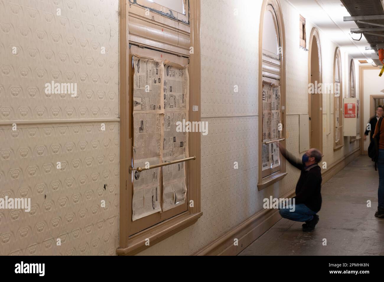 Visitors read the old newspapers taped to the windows by Melbourne ...