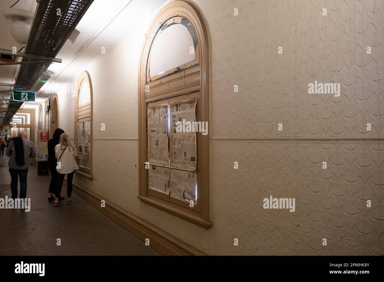 Visitors read the old newspapers taped to the windows by Melbourne ...