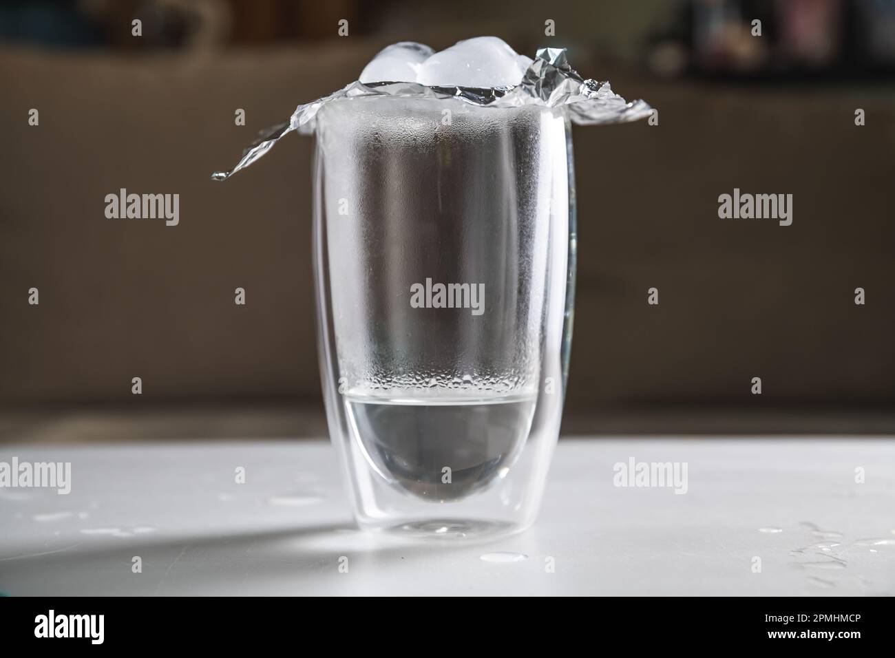 a schoolgirl conducts an experiment with hot water and ice. experience ...