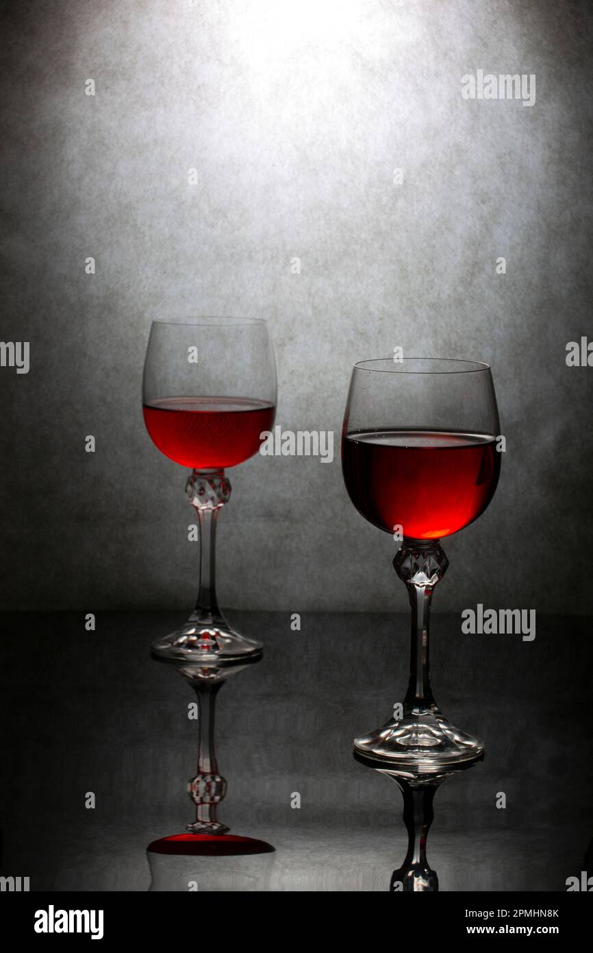 Still life with glasses with red liquid Stock Photo - Alamy