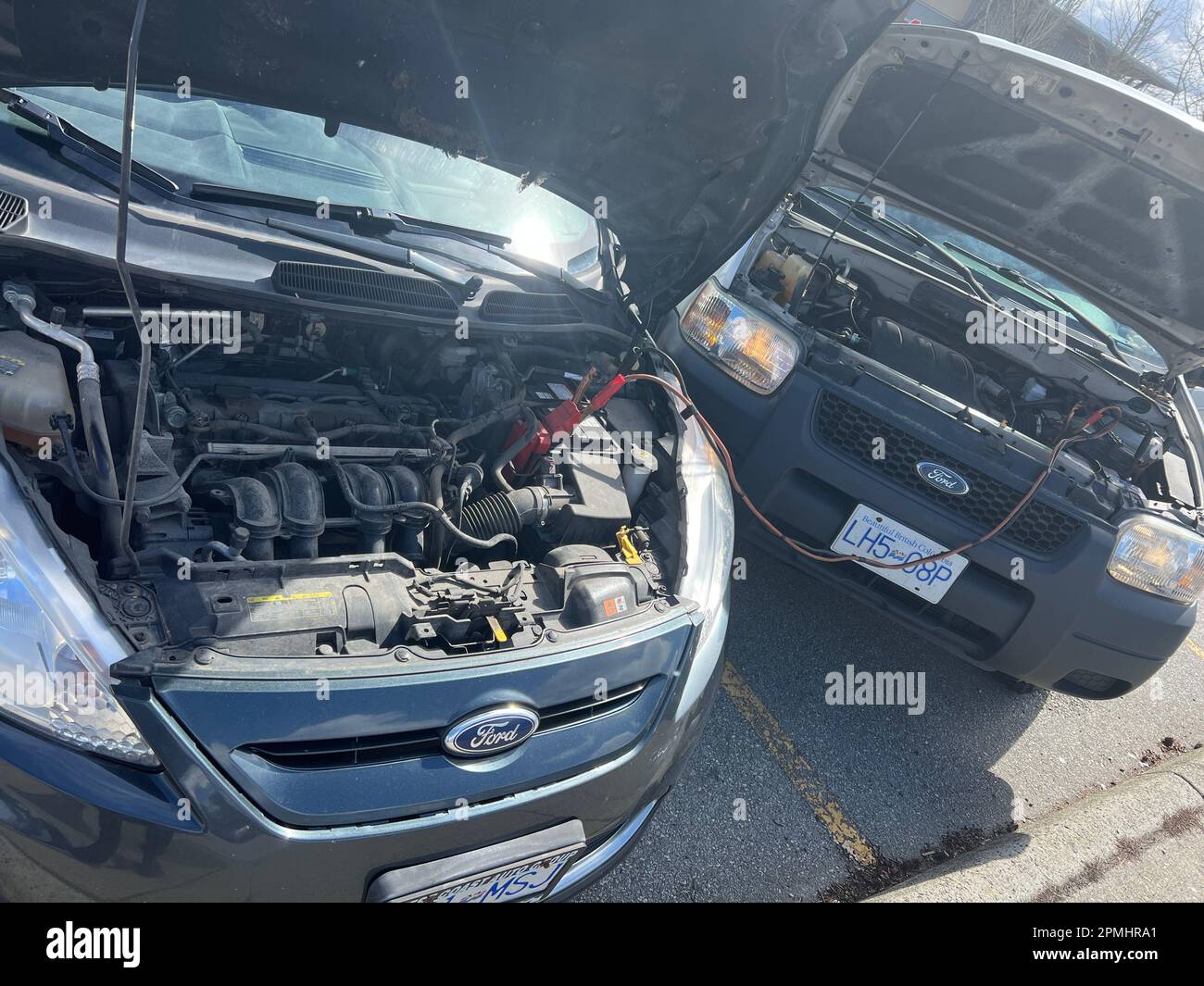Charging a car battery in winter. Help on the road. Close-up ...