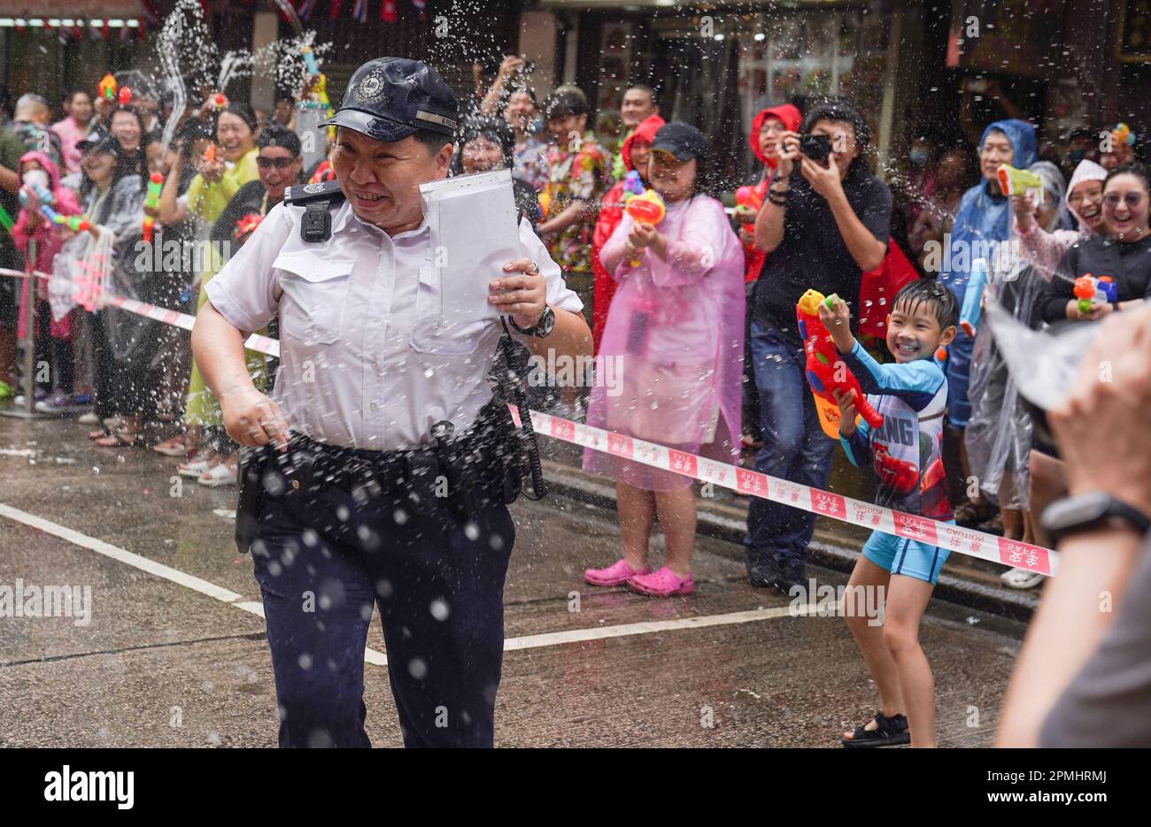 People splash water onto a police officer during Songkran Festival at ...