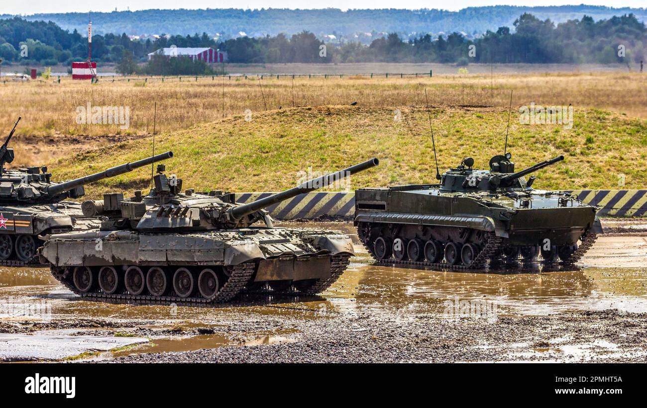 The main battle tank T-80U and infantry fighting vehicle BMP-3 of the Russian Army at ...