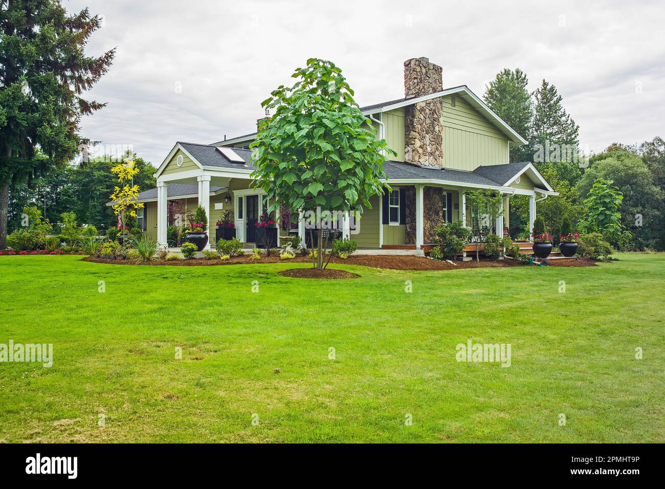 Nice house exterior with stone chimney and landscaping Stock Photo - Alamy