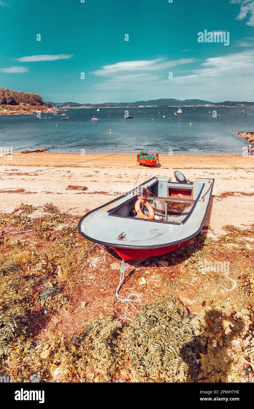 Shore with a beach and fishing boats in Galicia Stock Photo - Alamy