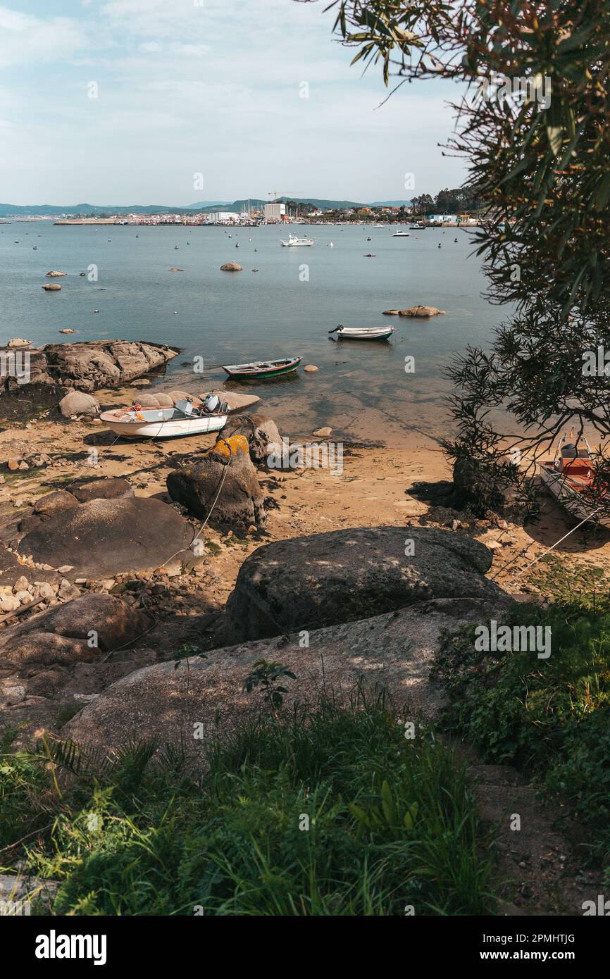 Shore with a beach and fishing boats in Galicia Stock Photo - Alamy