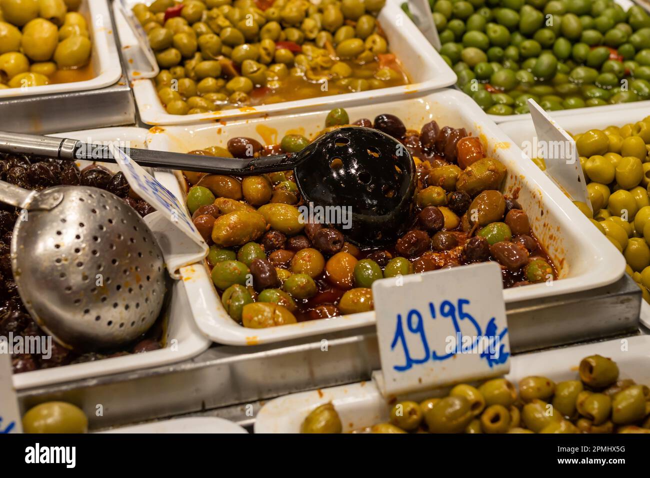 Different types of seasoned olives at a market in Seville (Spain Stock ...