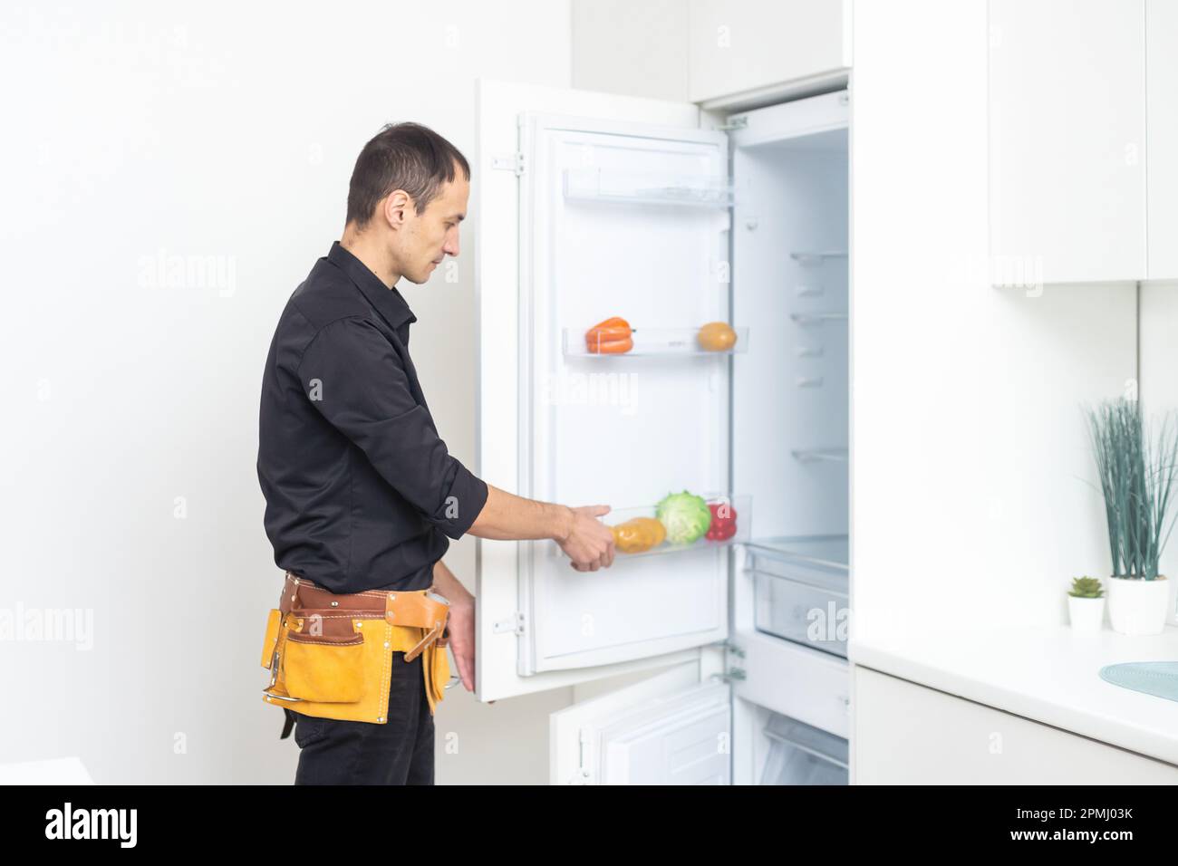 Worker repairing fridge in hi-res stock photography and images - Alamy