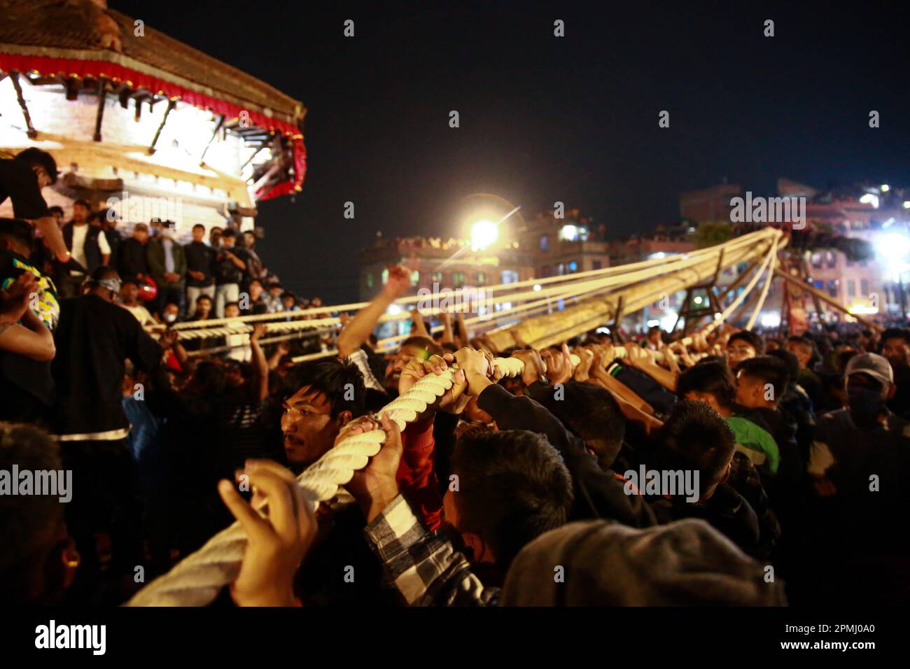 Nepal. 13th Apr, 2023. Hindu devotees pull a long ceremonial pole ...