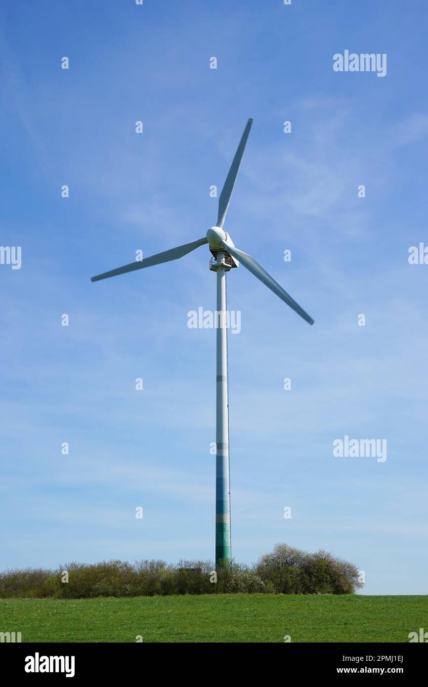 solitary three-bladed wind turbine in a meadow Stock Photo - Alamy
