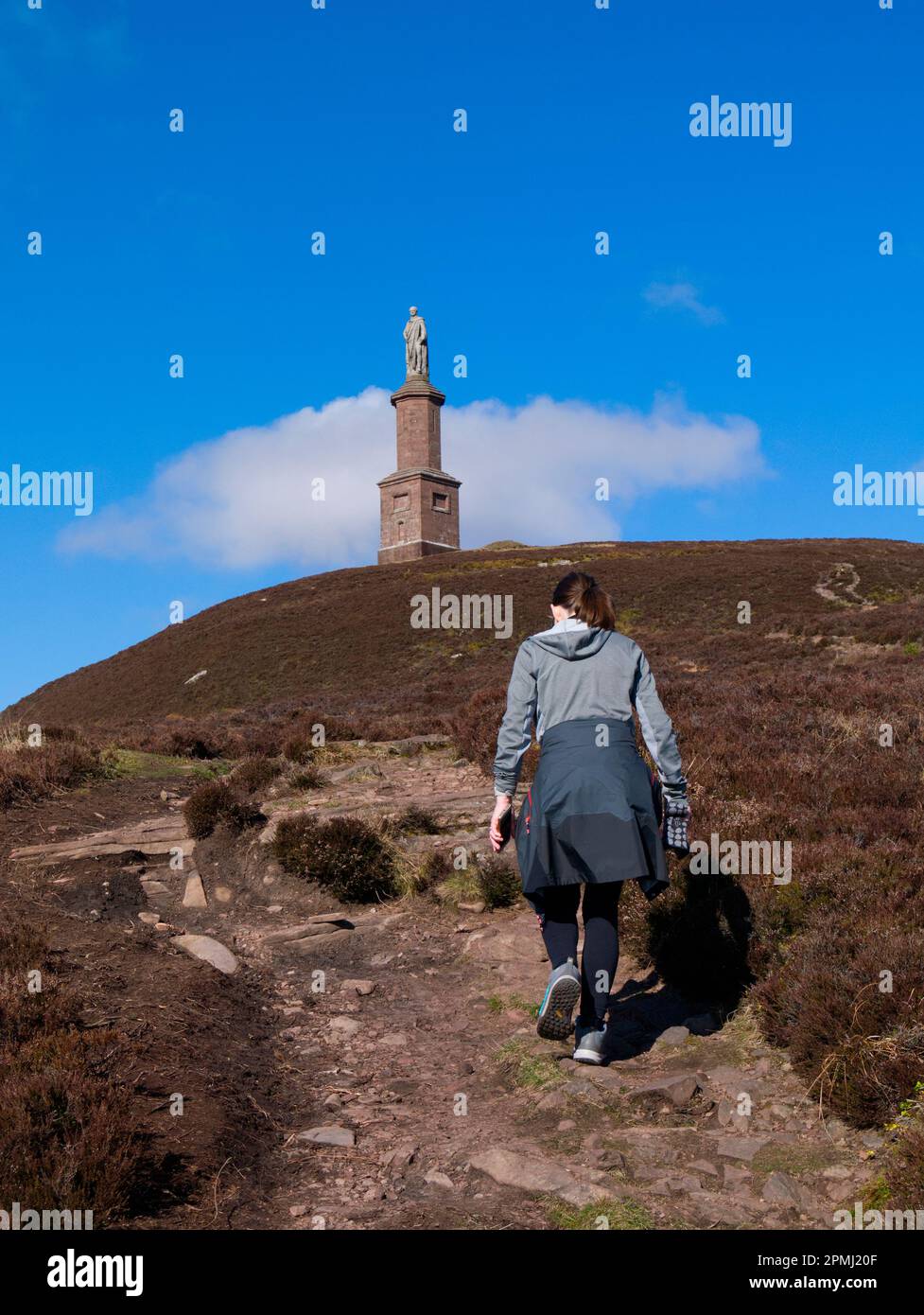 Female hiking up mountain path to summit of Ben Bhraggie, Sutherland ...