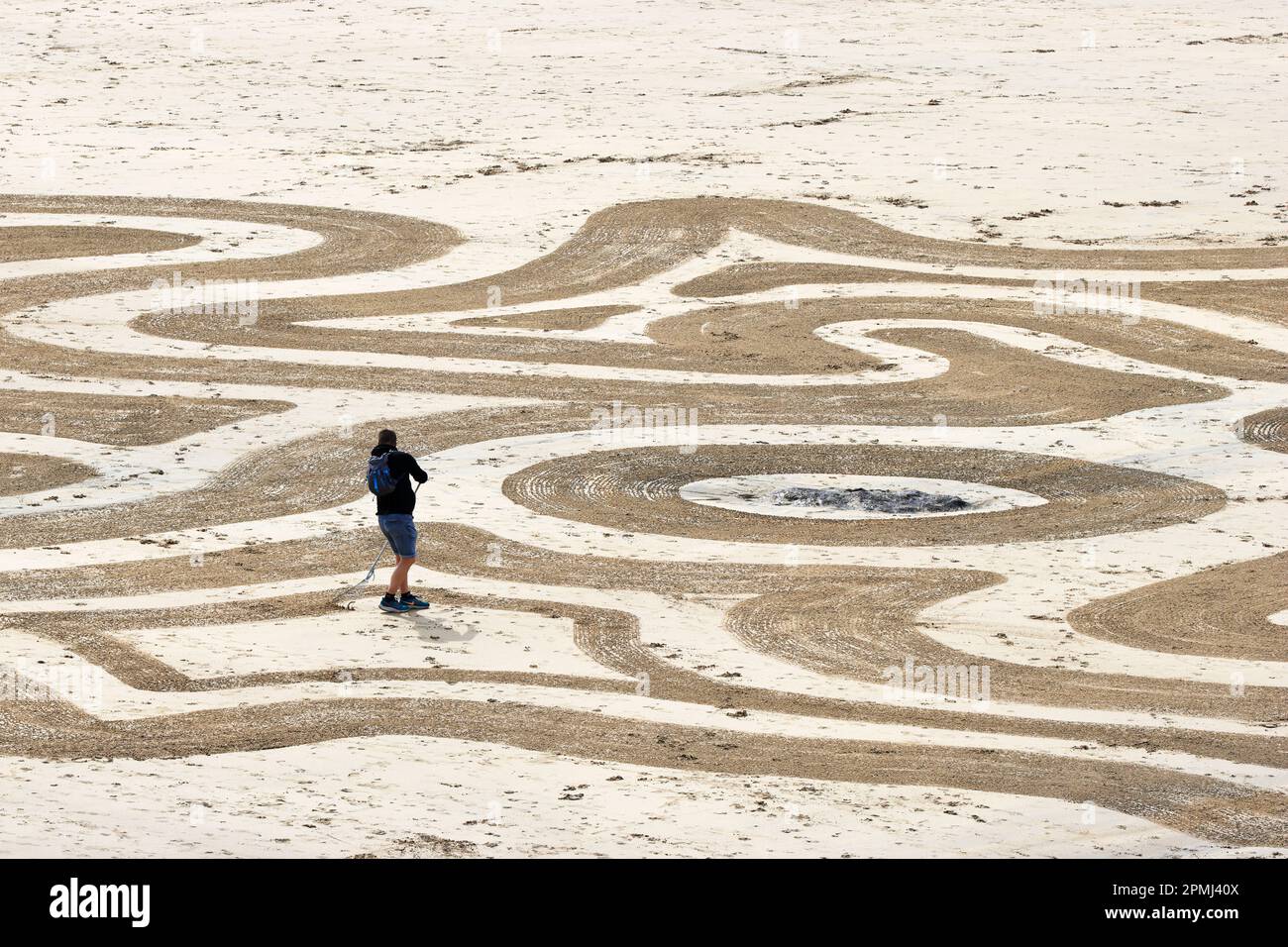 Beach sand artist and his work near Godrevy Point, North Coast of ...