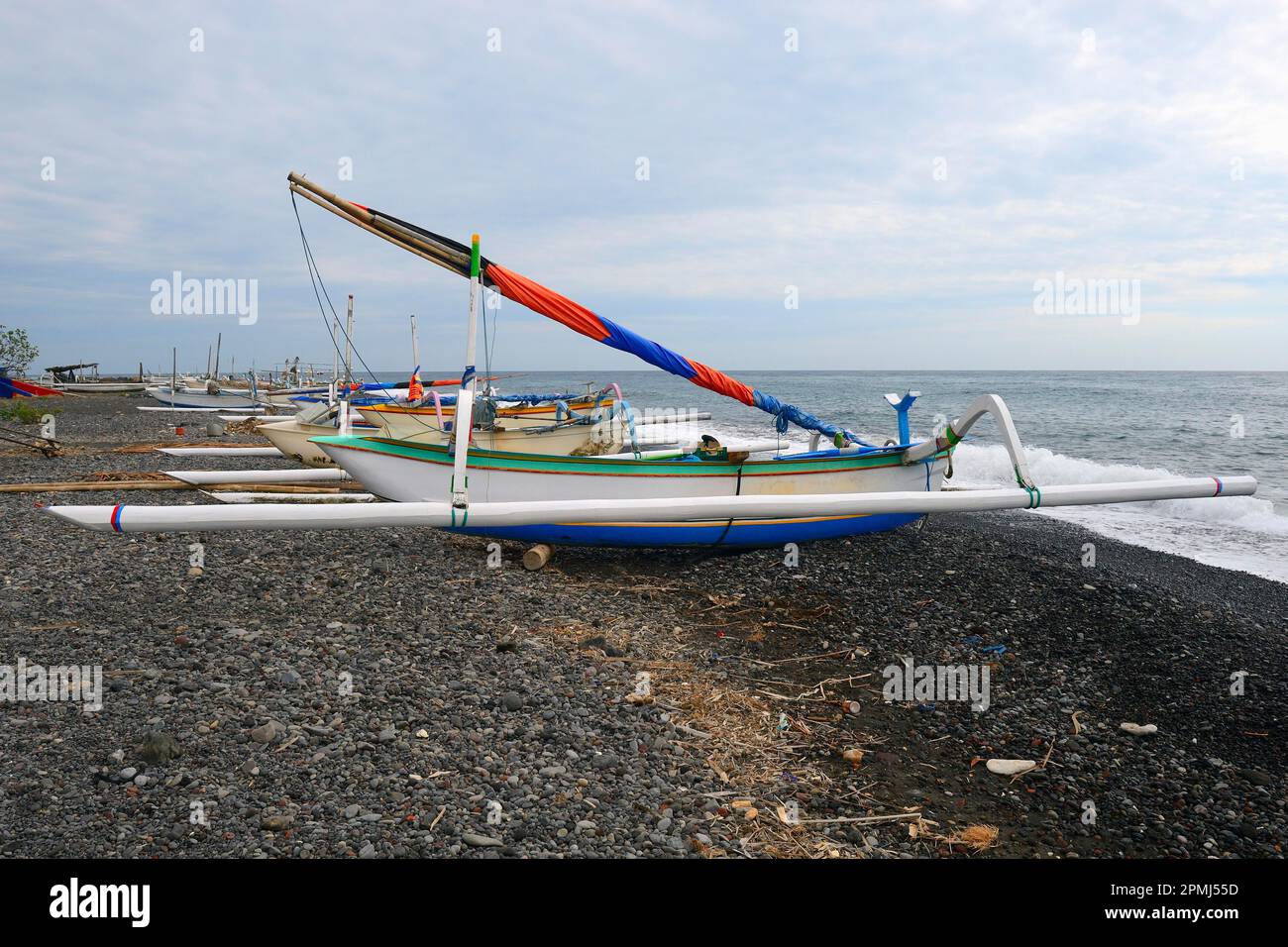 Traditional colourful outrigger boats on the black lava beach of Lovina ...