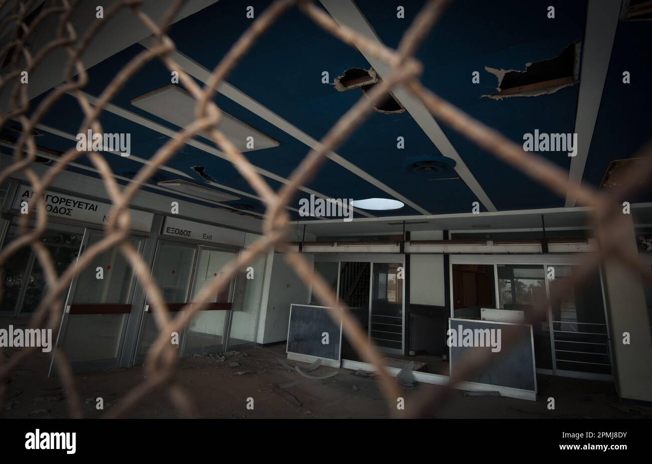 Interior of deserted and abandoned airport terminal. Damaged furniture ...