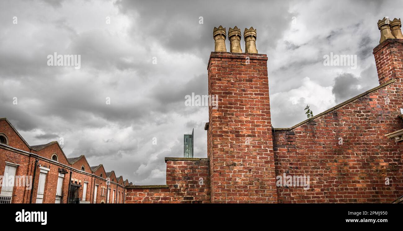 Traditional brick buildings in Manchester contrast with the Beetham ...
