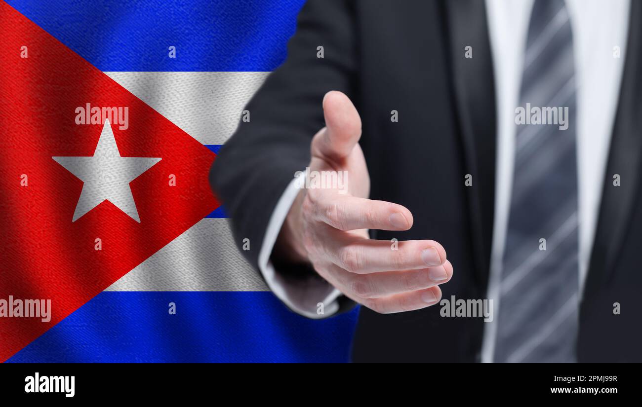 Cuba politics, cooperation and travel concept. Hand on Cuban flag ...
