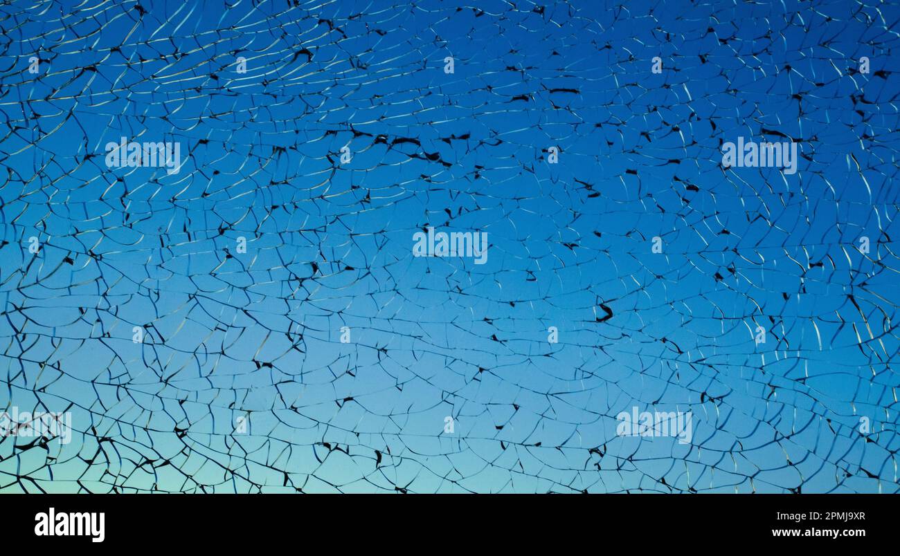 Blue broken shattered glass with black cracks Stock Photo - Alamy
