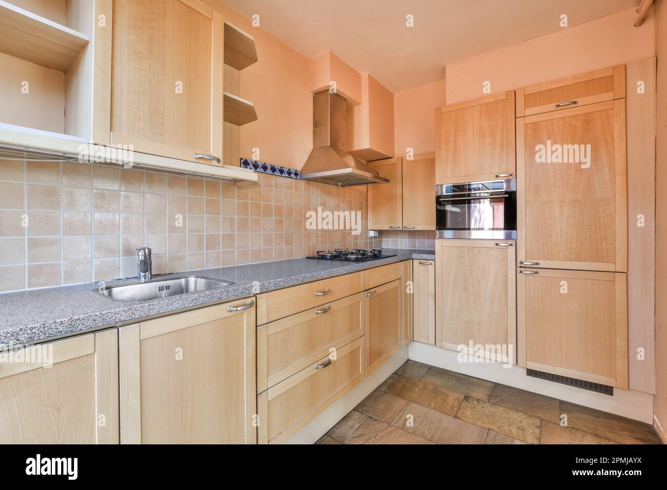 a kitchen with wood cabinets and granite counter tops on the counters ...