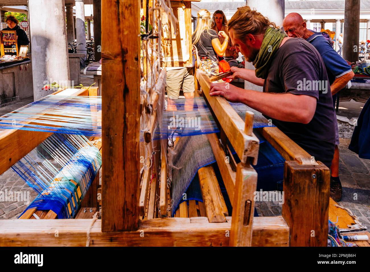 Craftsman manufactures cloth on an old loom. Craft market in the ...