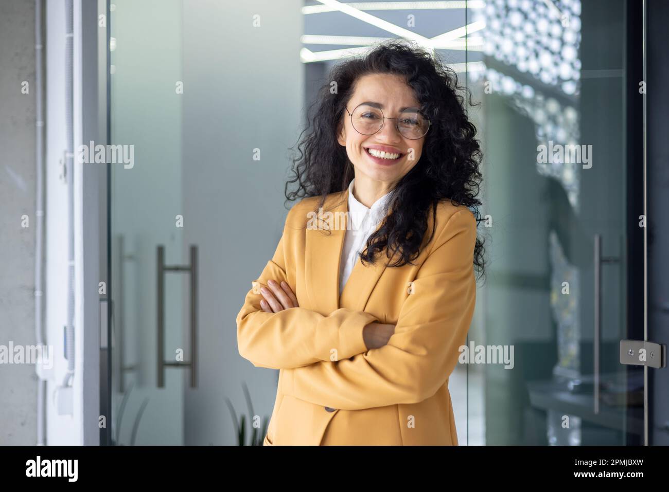Portrait of successful business woman inside office, latin american ...