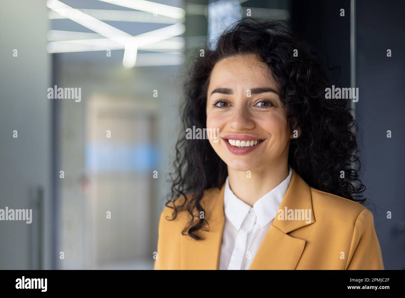 Beautiful and happy hispanic business woman in the office, isolated ...