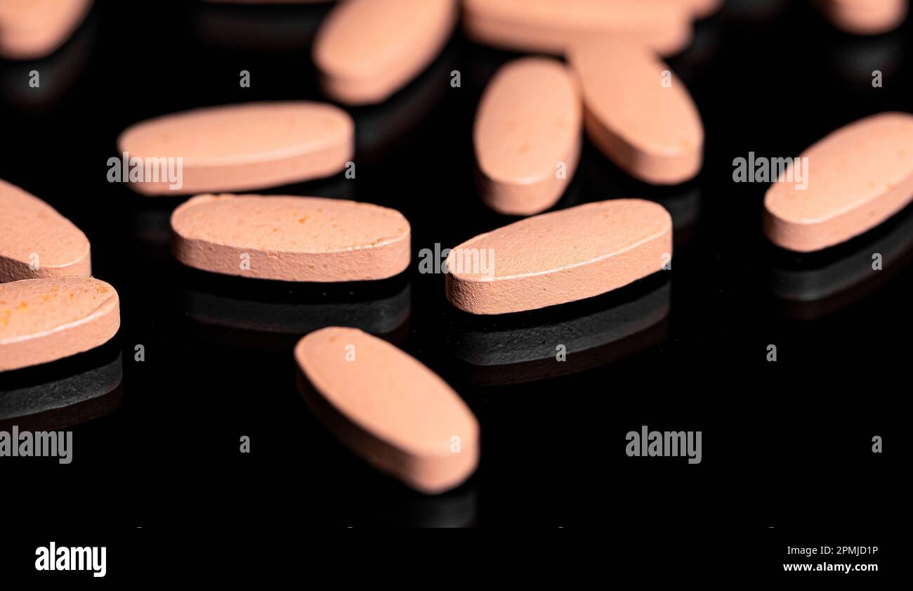pill tablets that are pink and have their caps turned red Stock Photo ...