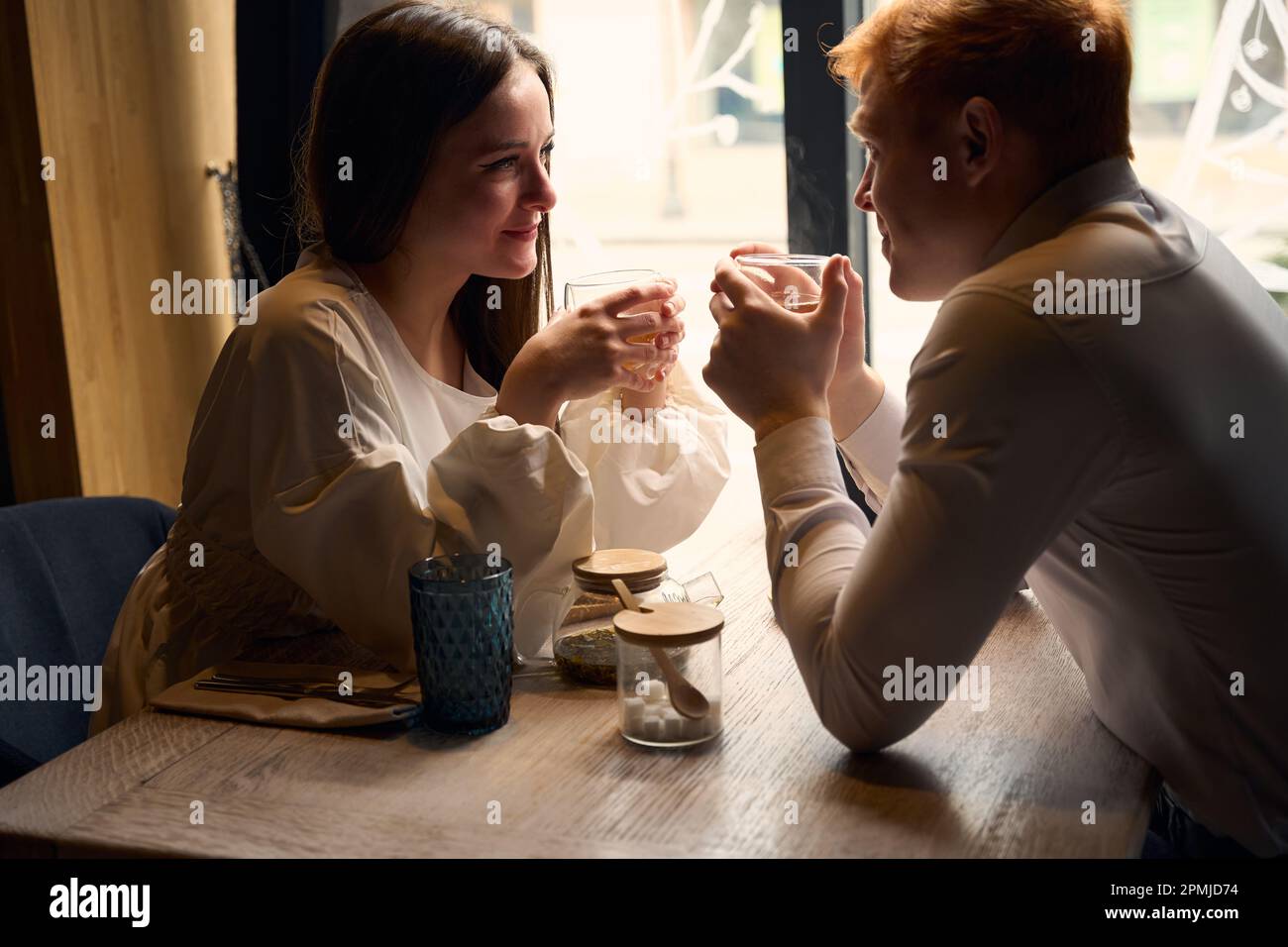 Guy and his girlfriend look into each others eyes Stock Photo - Alamy