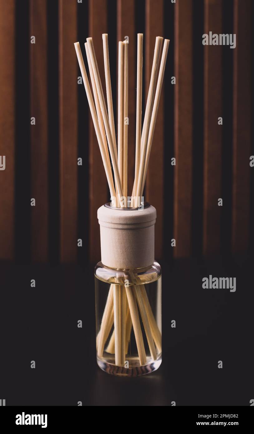 home fragrance bottle with rattan sticks and smell of freshness on dark ...
