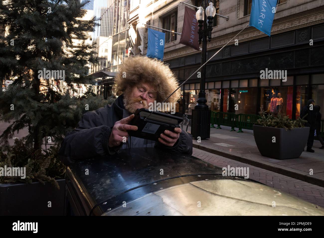 Boston, USA. 8 Mar, 2023. A man smoking a cigarette on a sidewalk with ...