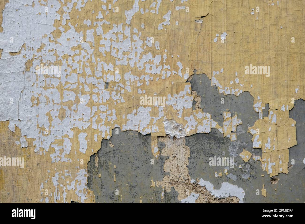 Detail of old painted wall with scraps of flaking paint layers, grunge ...