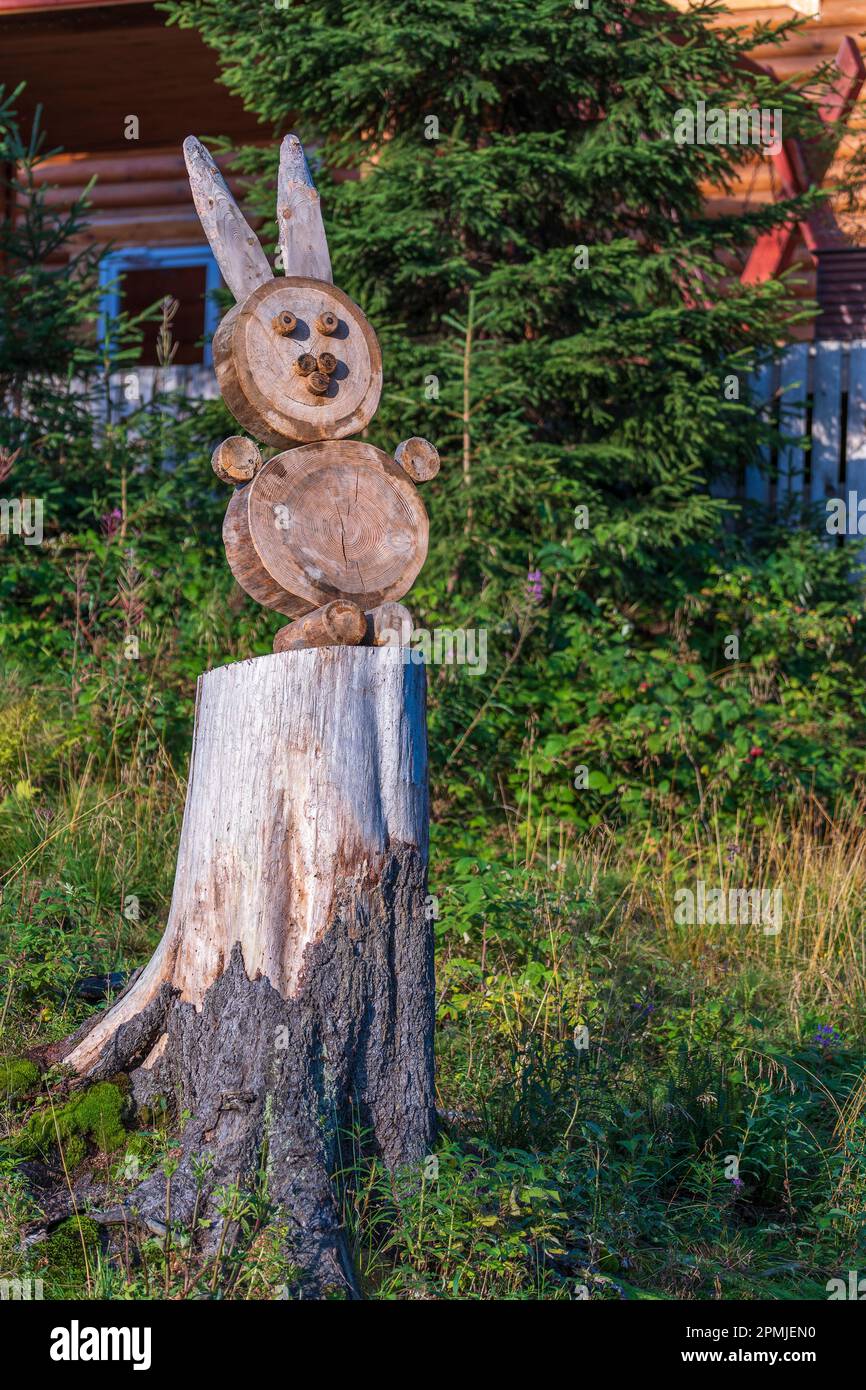 Wooden hare from a felled tree on a stump along the road in the ...