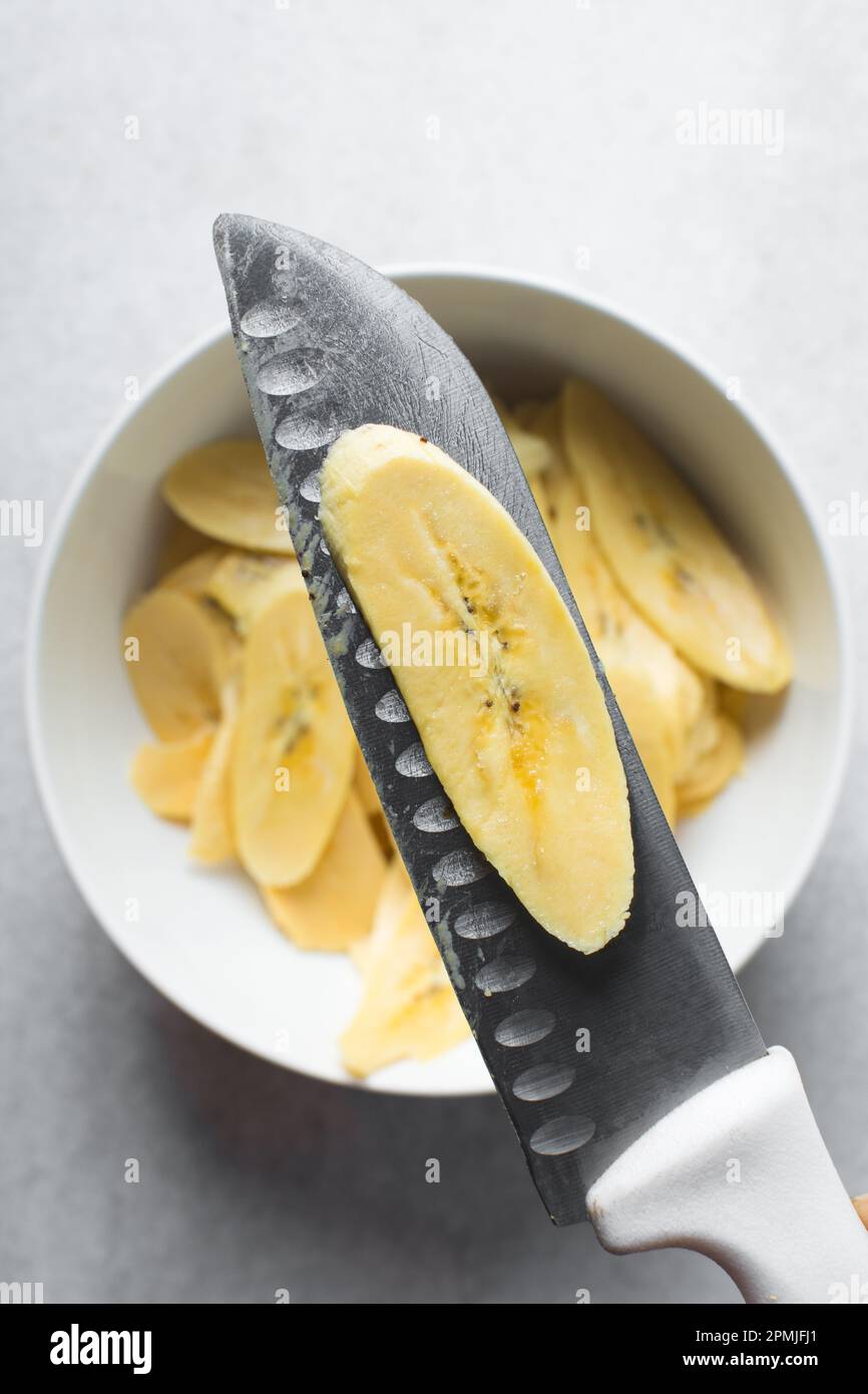 Overhead view of yellow ripe plantains on a white countertop, top view ...