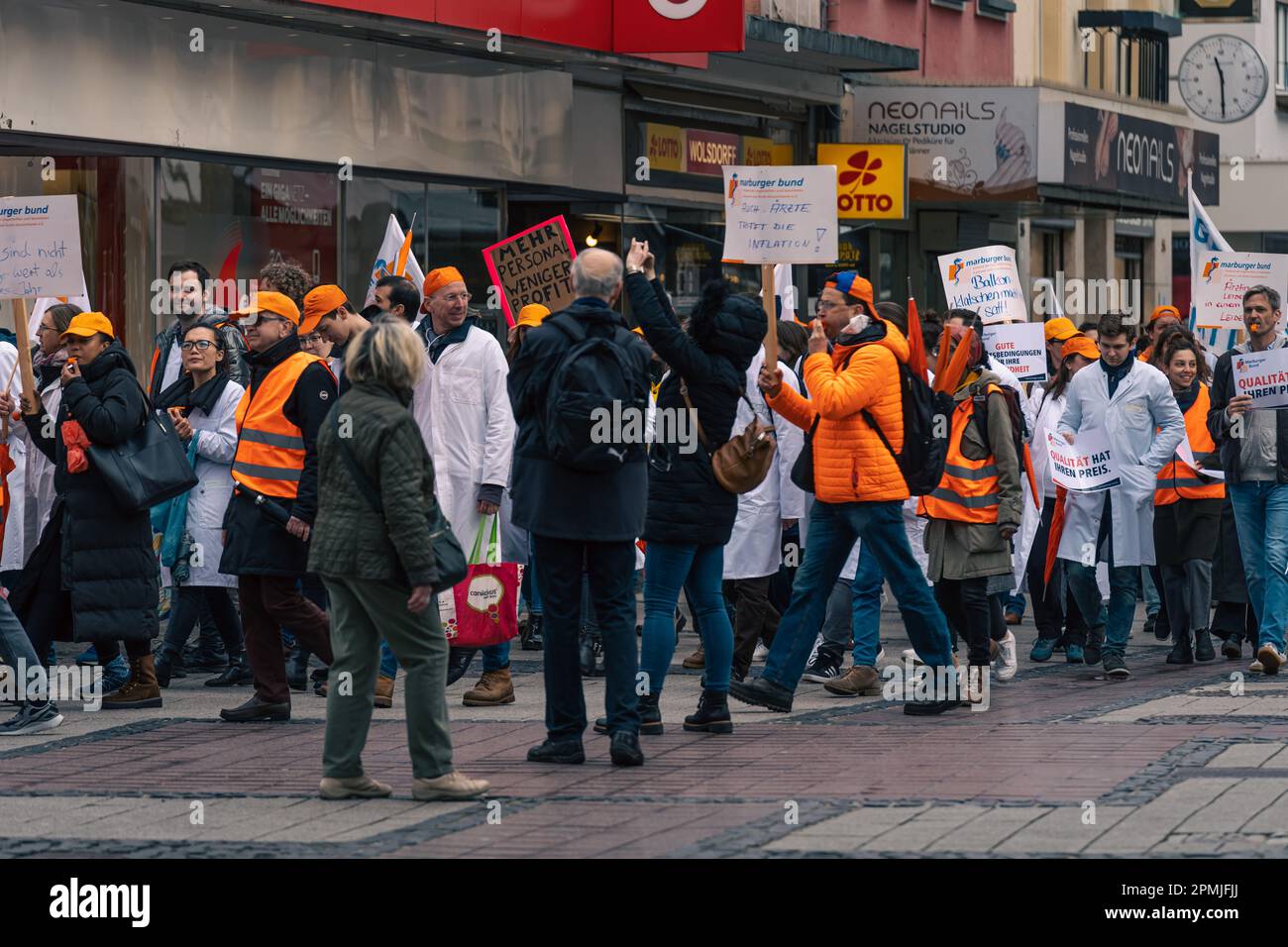 German doctors and caregivers marching with protest signs under the ...