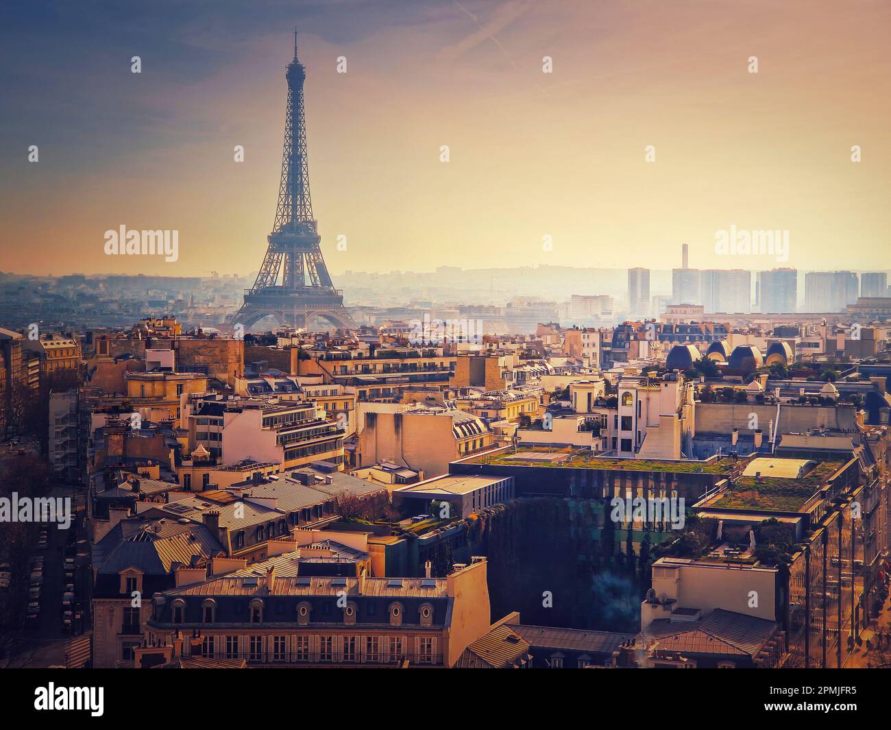 Smog over Paris city, France. Foggy sunset view to the Eiffel Tower due ...