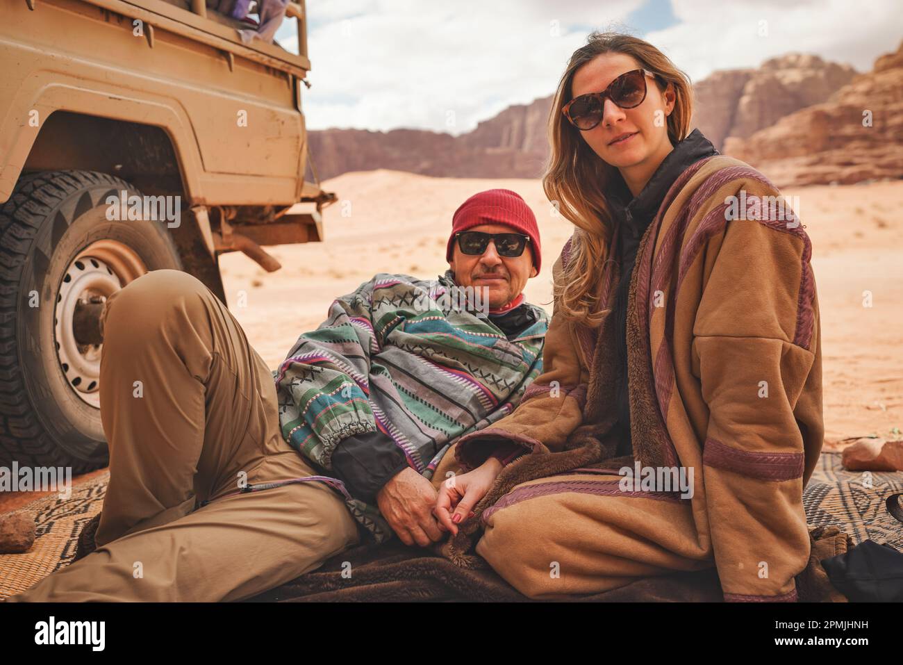 Man and younger woman wearing traditional Bedouin warm coat - bisht ...