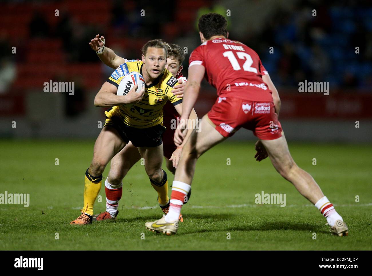 Castleford Tigers’ Jacob Miller is tackled by Salford Red Devils’ Sam ...