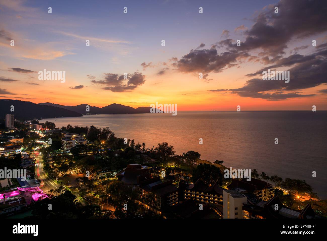 Aerial dusk sunset view of luxury hotels on Batu Ferringhi beach ...