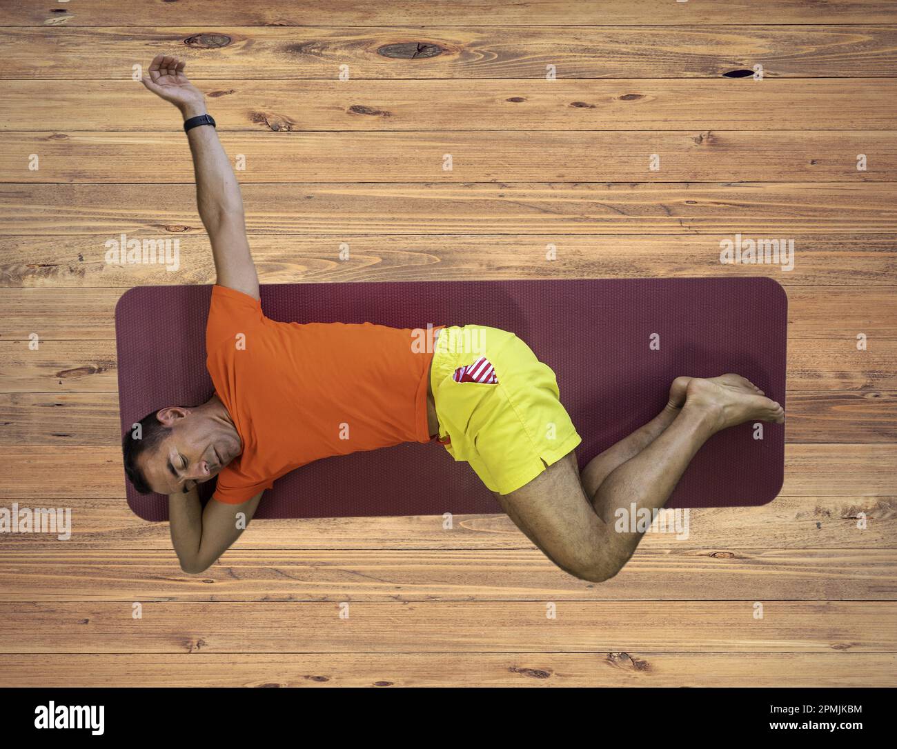 gymnastics, a man exercises on a mat, home exercise, wooden floor ...