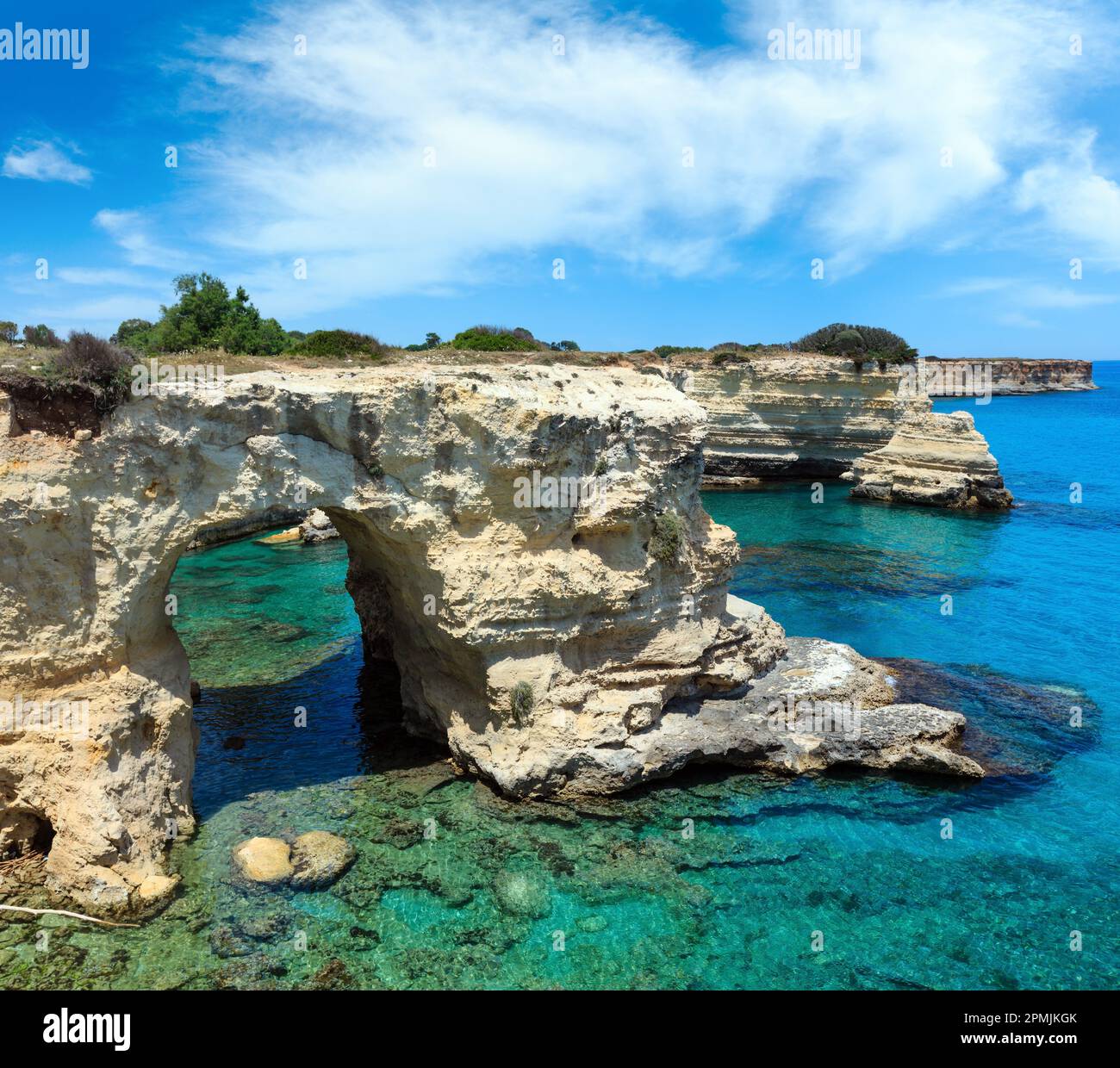 Picturesque seascape with cliffs, rocky arch and stacks (faraglioni ...